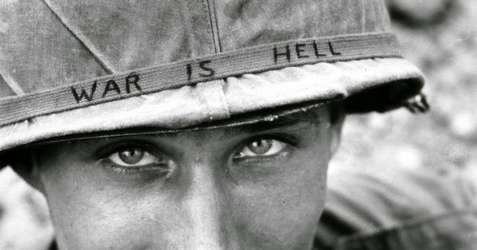 An American soldier wears a hand lettered War Is Hell slogan on his ...